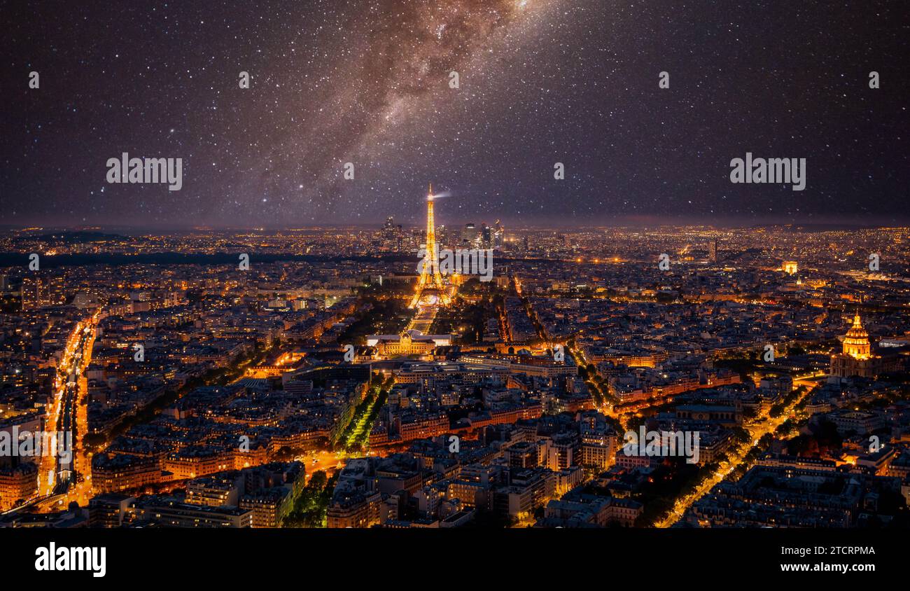 The Eiffel Tower at night under the Milky Way galaxy in Paris, France. Aerial view from ...