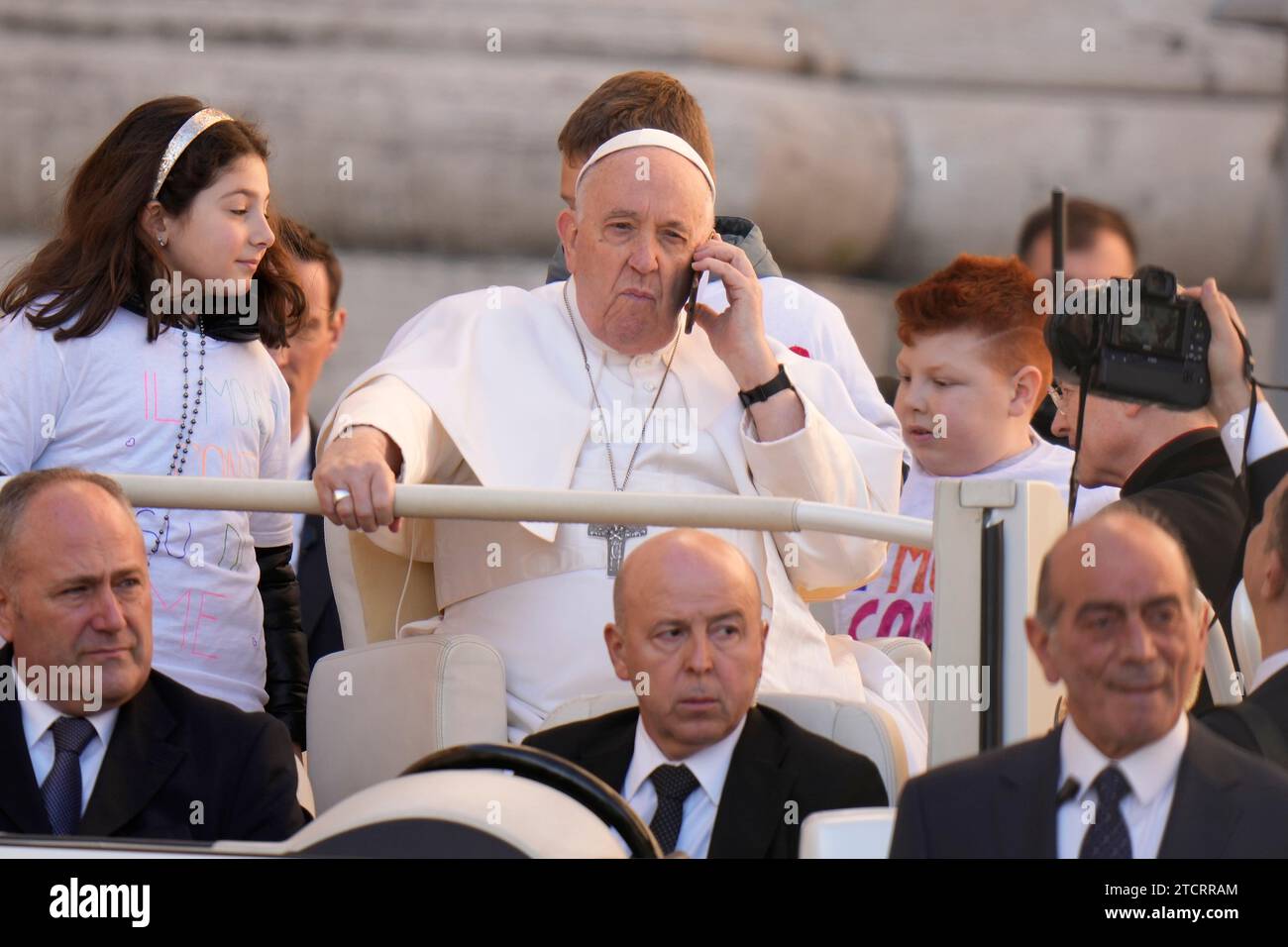 FILE - Pope Francis talks on a phone as he arrives for his weekly ...