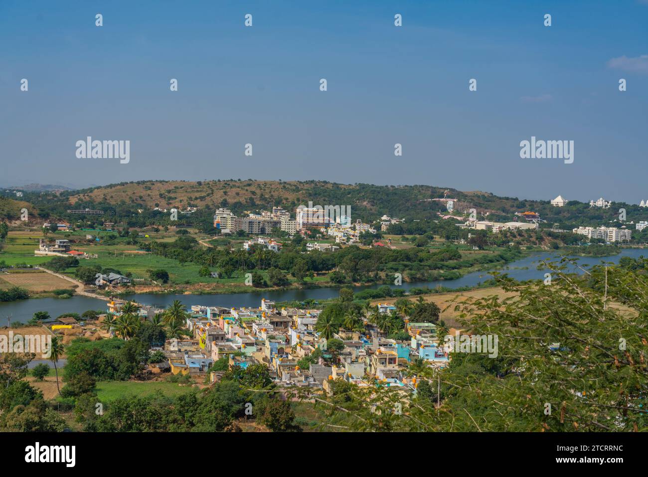 Landscape from Puttaparthi with the lake green trees,buildings, temple ...