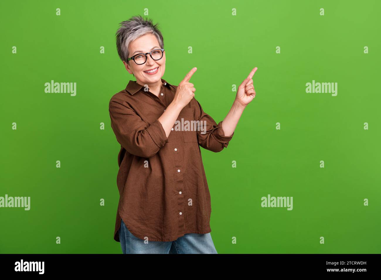 Portrait of optimistic clever person with short hair in eyewear indicating at proposition empty ...