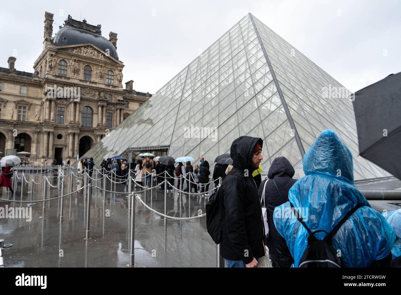 Visitors queuing to enter the Louvre Museum on December 12, 2023 in ...