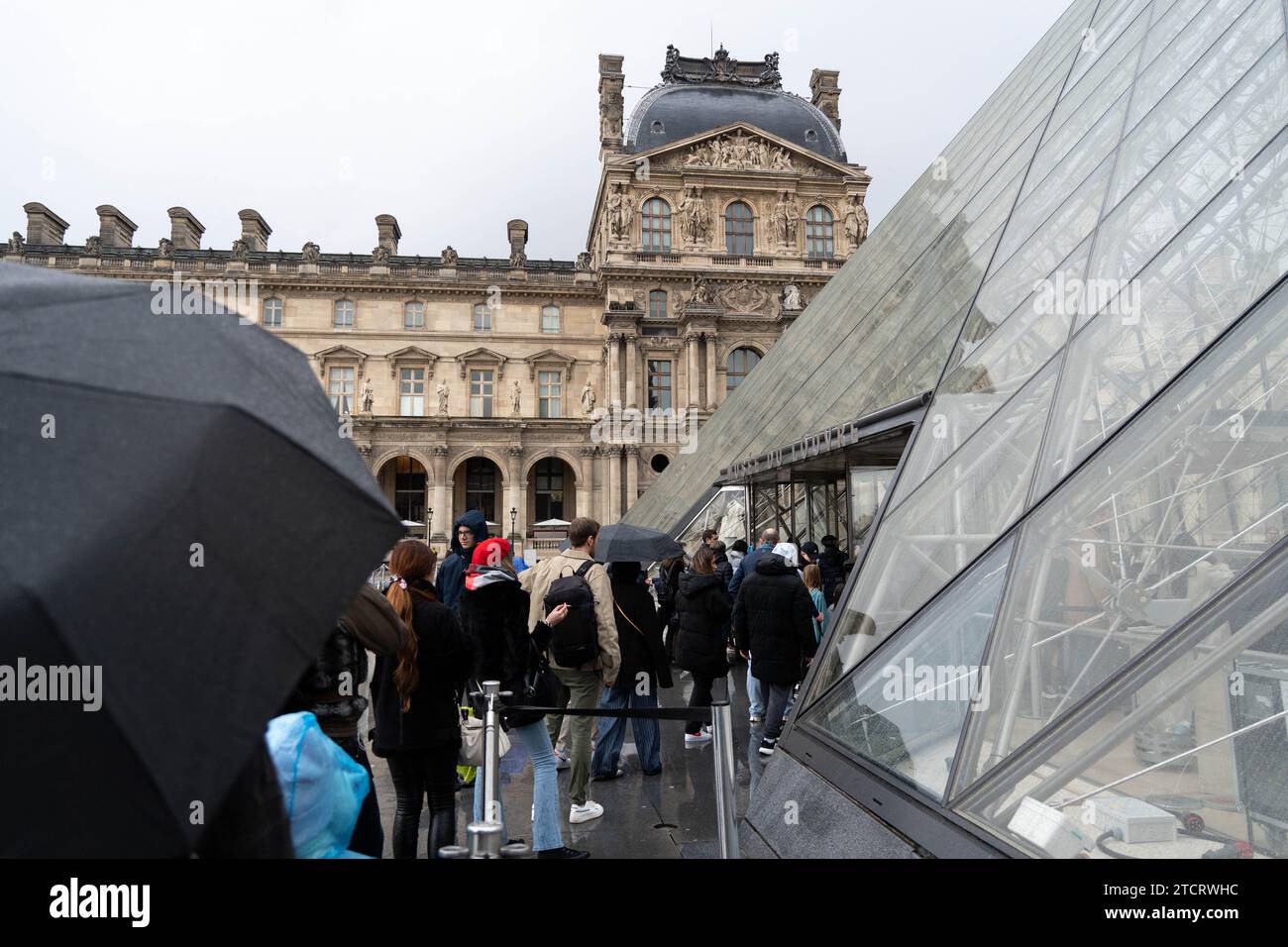 Visitors queuing to enter the Louvre Museum on December 12, 2023 in ...