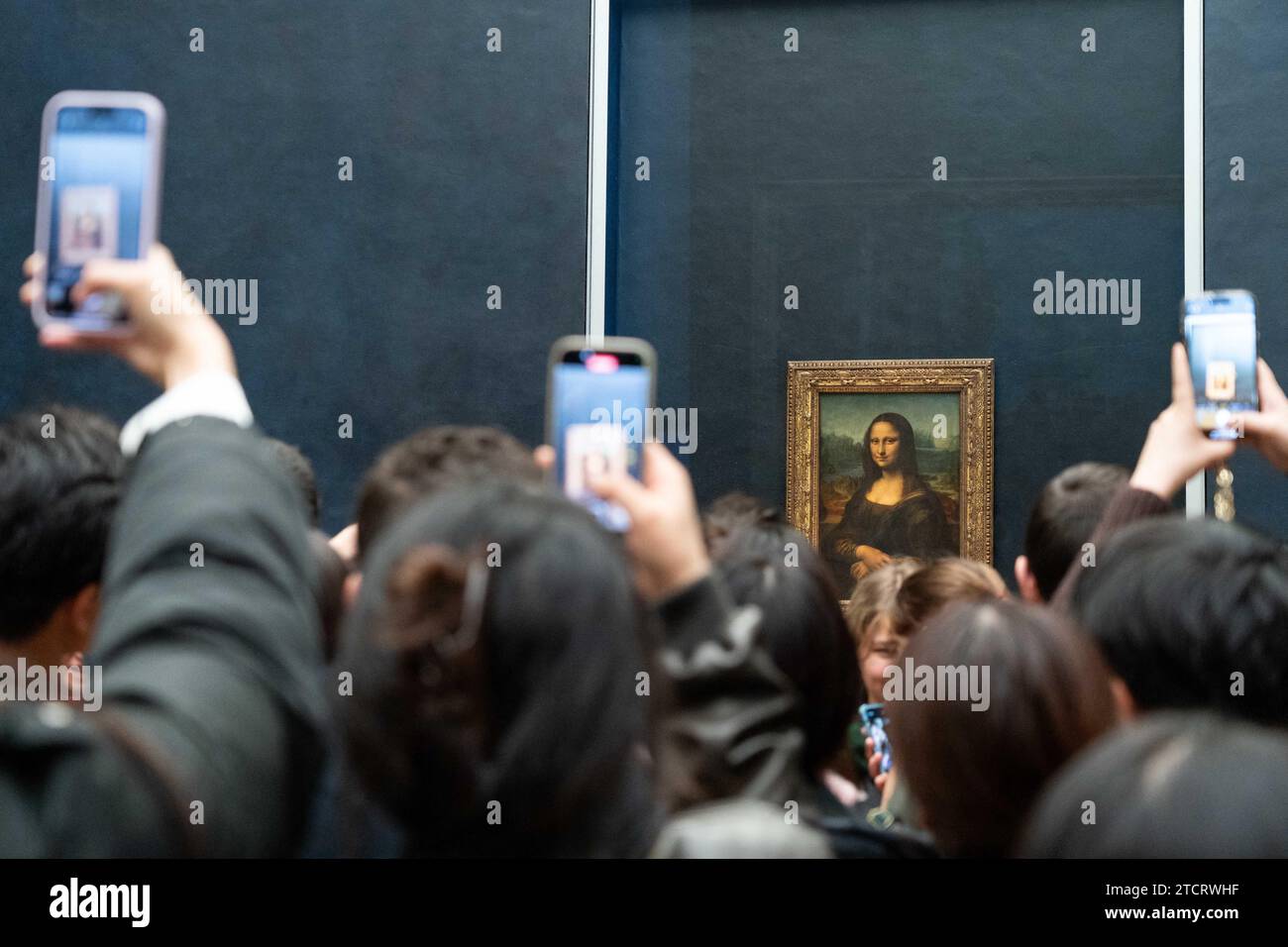 Visitors take pictures of Mona Lisa (La Joconde) painting with their ...