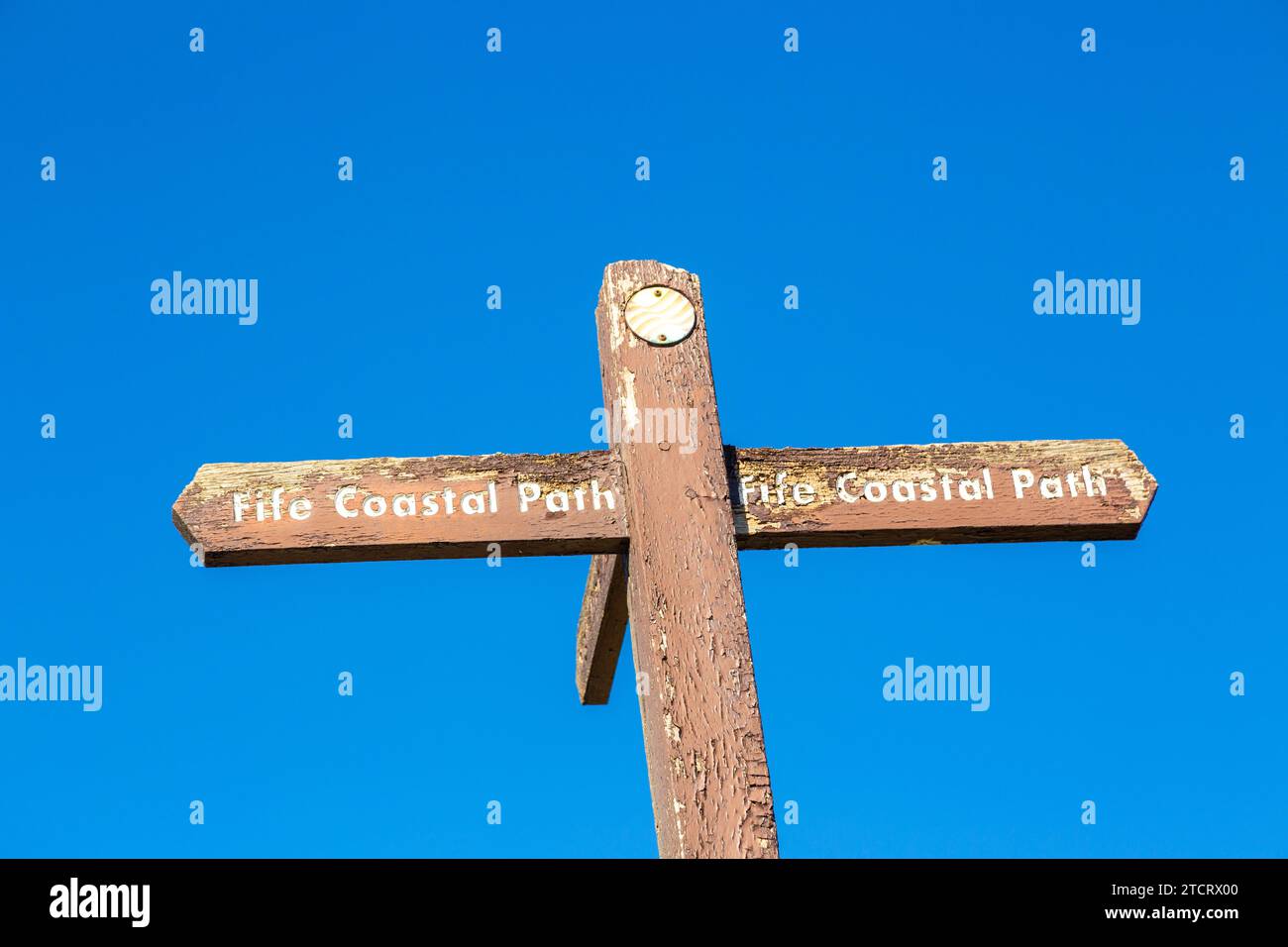 A wooden Fife Coastal Path Sign against a blue sky Stock Photo - Alamy