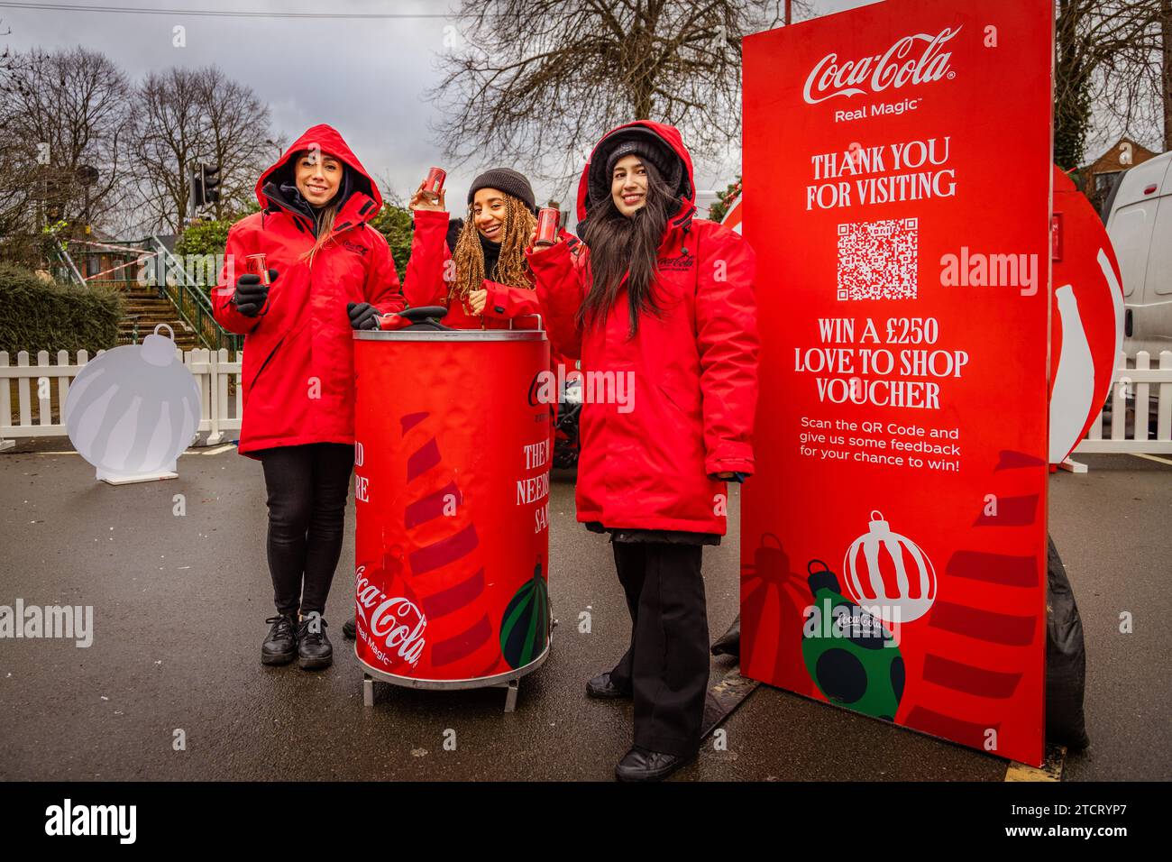 Coca Cola promotions girls raise a can of the iconic drink at a stop ...