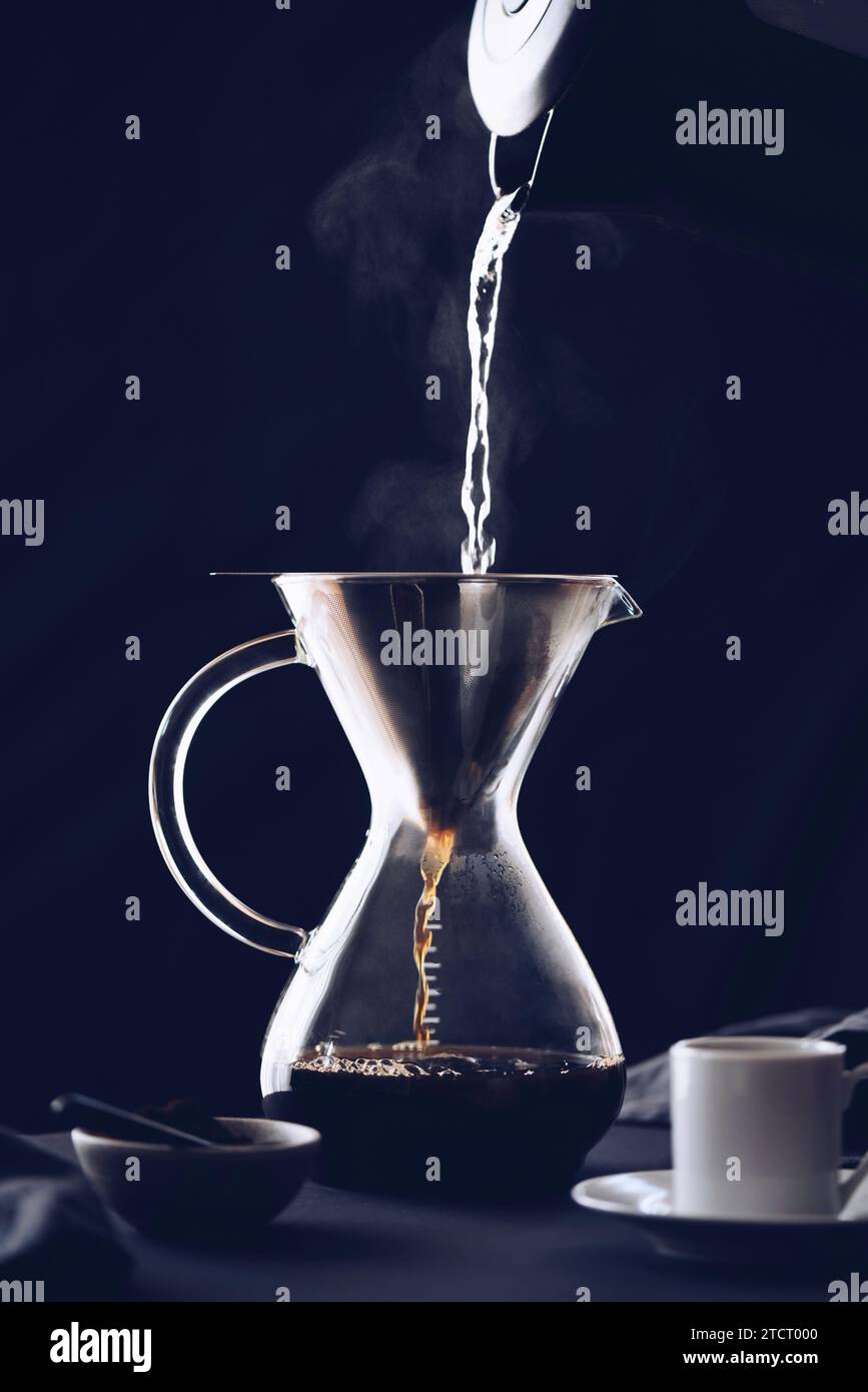 Brewing coffee with a filter dripper. Coffee dripping through a paper ...
