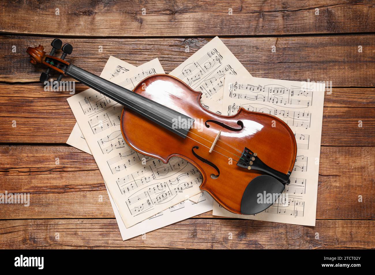 Violin and music sheets on wooden table, top view Stock Photo - Alamy