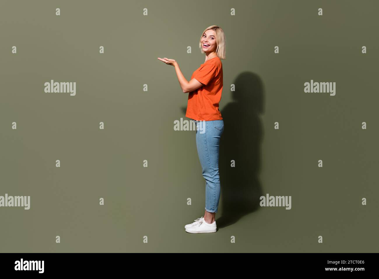 Full length body side photo of surprised young woman hold hands ...