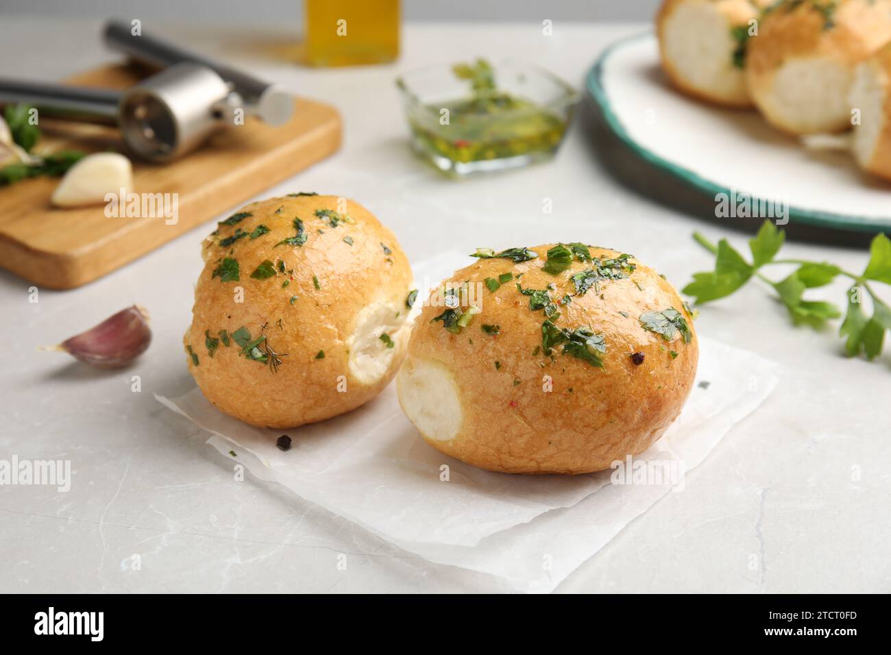 Traditional Ukrainian bread (Pampushky) with garlic on light table ...