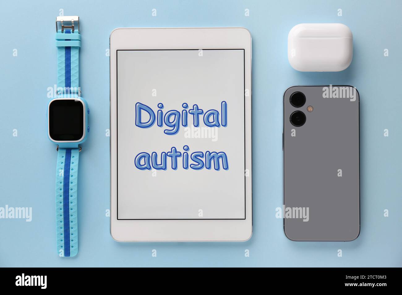Tablet with phrase Digital Autism and devices on light blue background ...