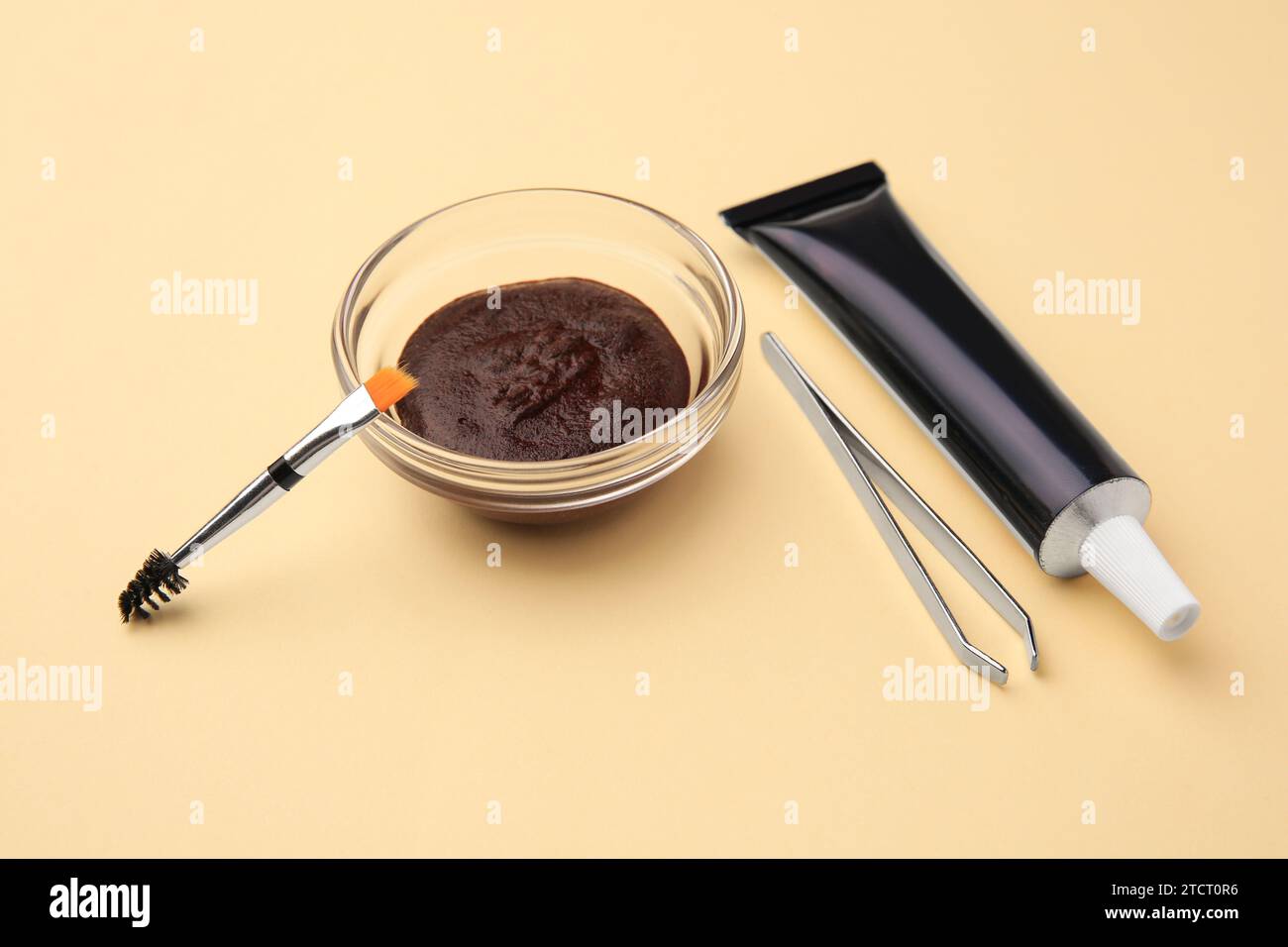 Eyebrow henna and tools on beige background Stock Photo - Alamy