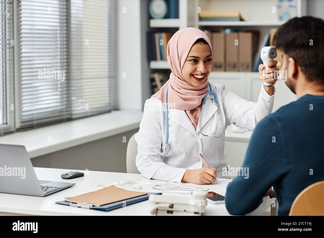 Portrait of Smiling Muslim Doctor Checking Temperature Stock Photo - Alamy