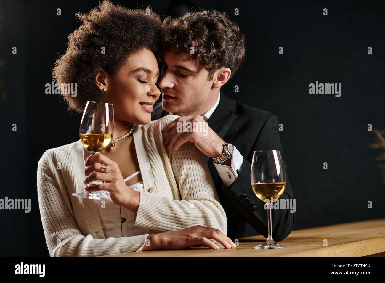 handsome man flirting with african american woman sitting at bar ...