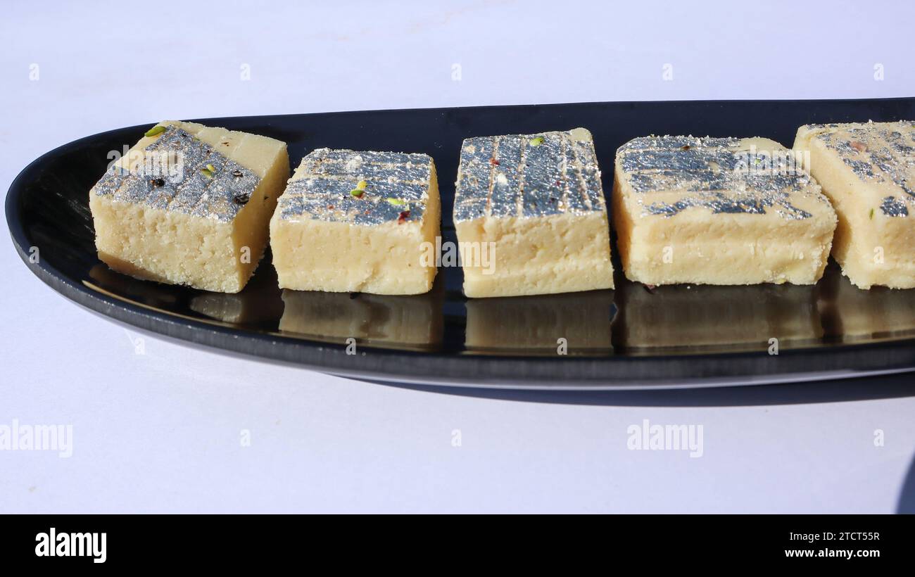 MIlk barfi or Milk khoya burfi. Indian sweets Barfee with silver foil ...