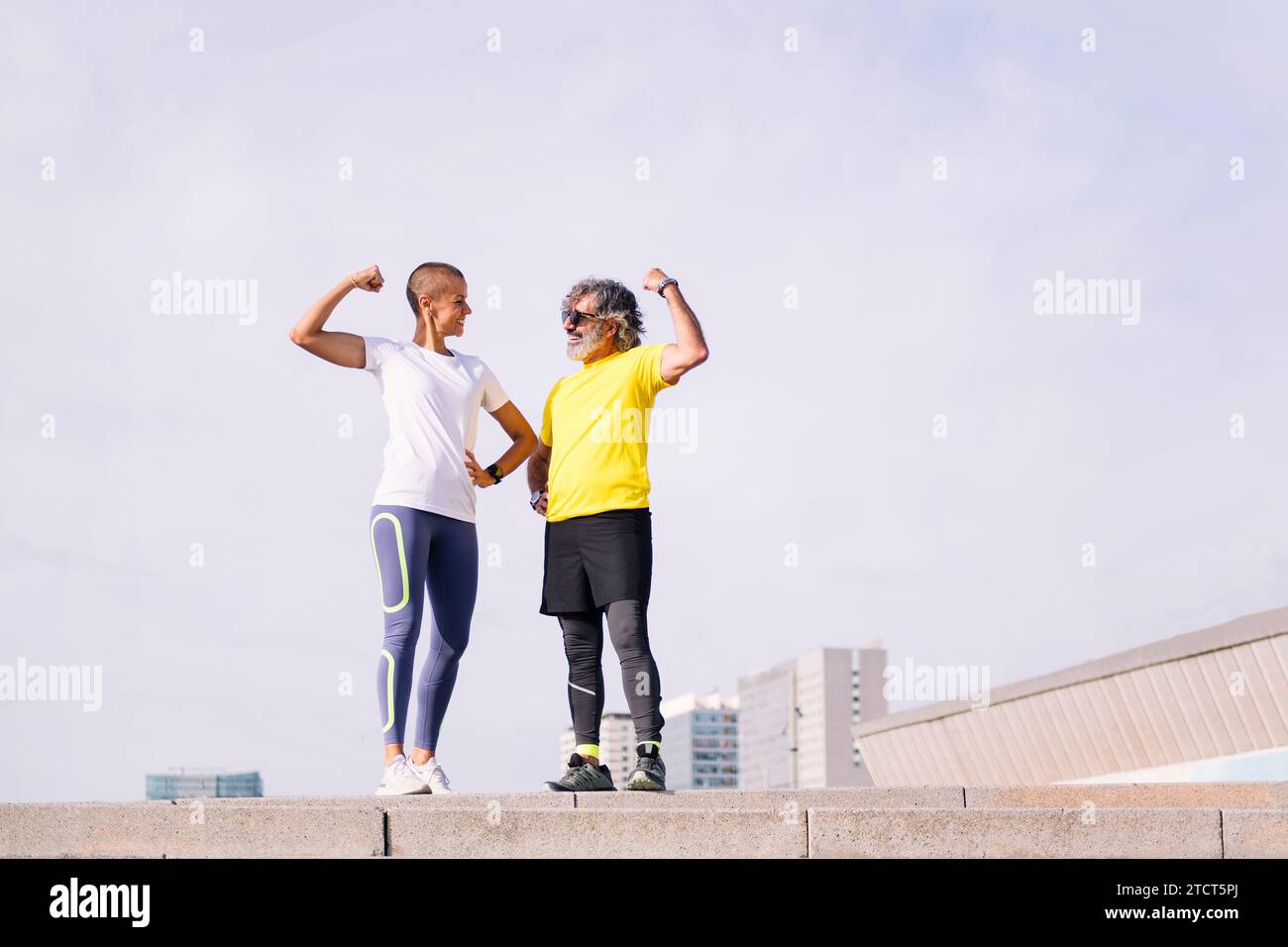 man and trainer celebrating success showing muscle Stock Photo - Alamy