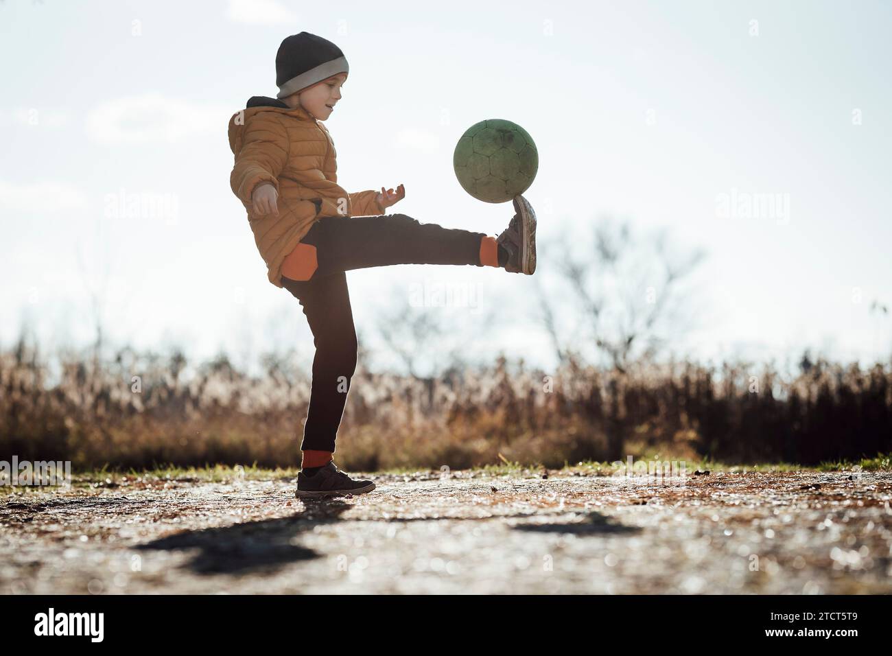 Young boy playing football outdoor Stock Photo - Alamy
