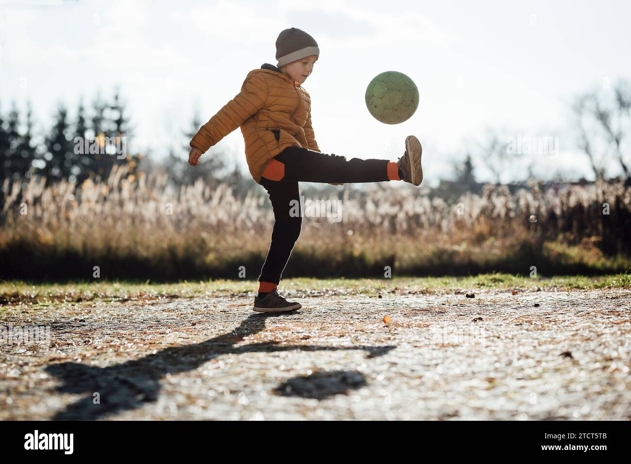 Young boy playing football outdoor Stock Photo - Alamy