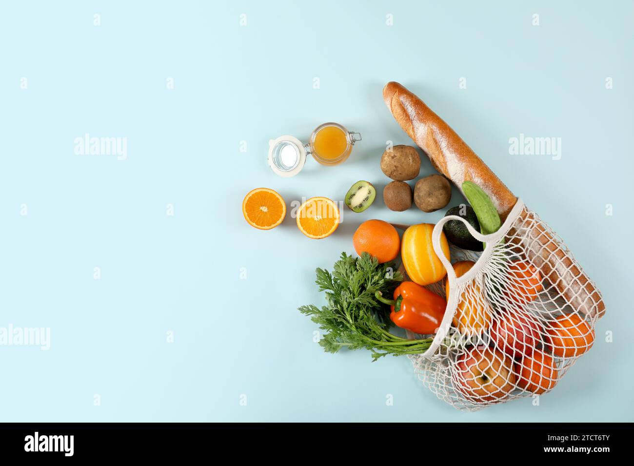Grocery ingredients in a net bag are isolated on a solid background ...