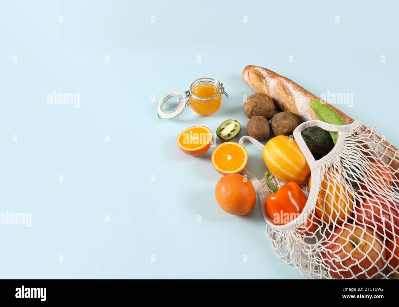 Grocery ingredients in a net bag are isolated on a solid background ...