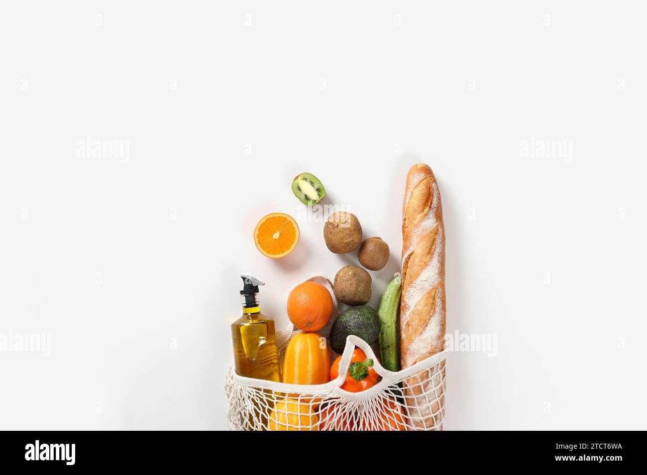 Grocery ingredients in a net bag are isolated on a solid background ...
