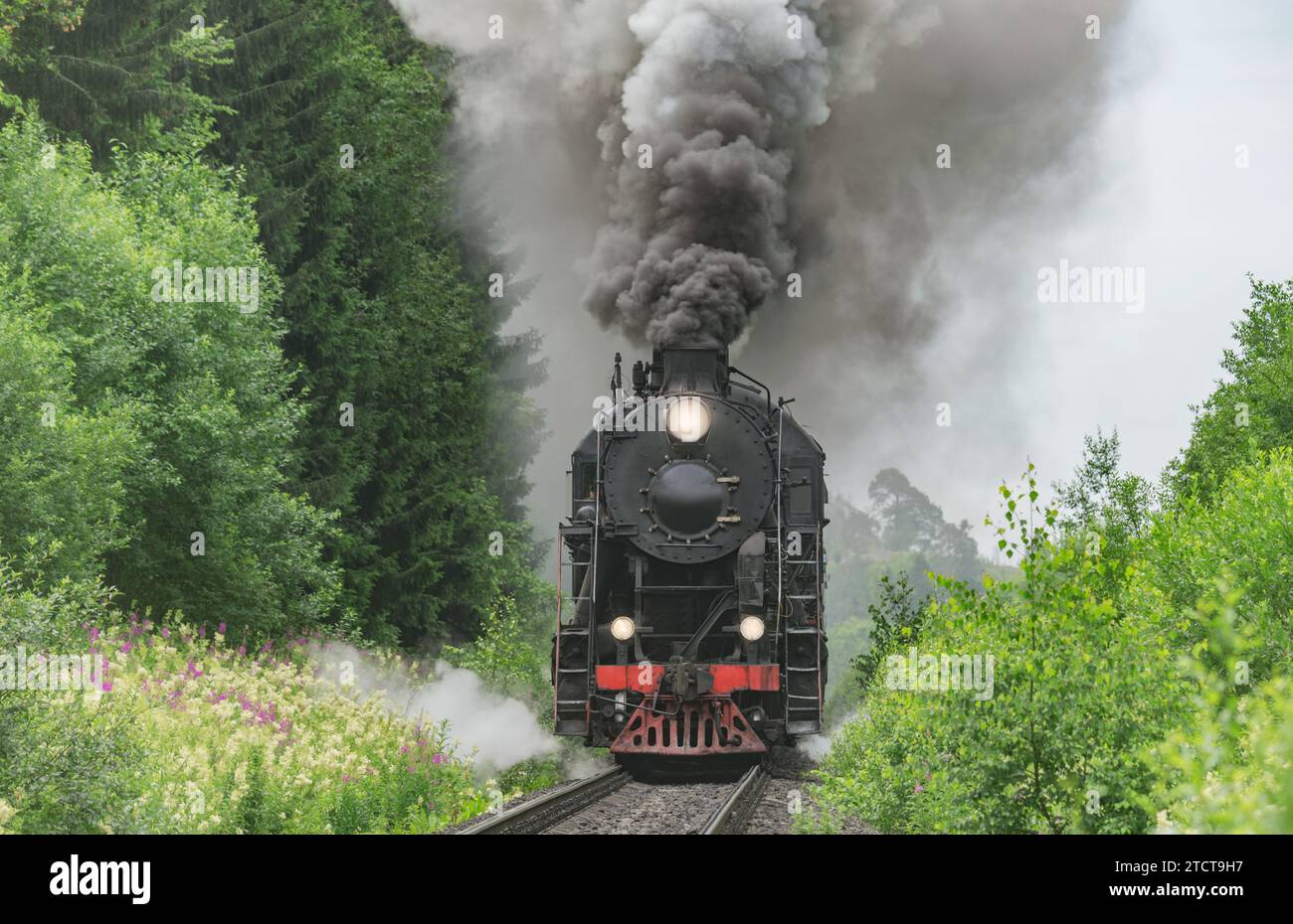 Retro steam train approaches to the platform Stock Photo - Alamy