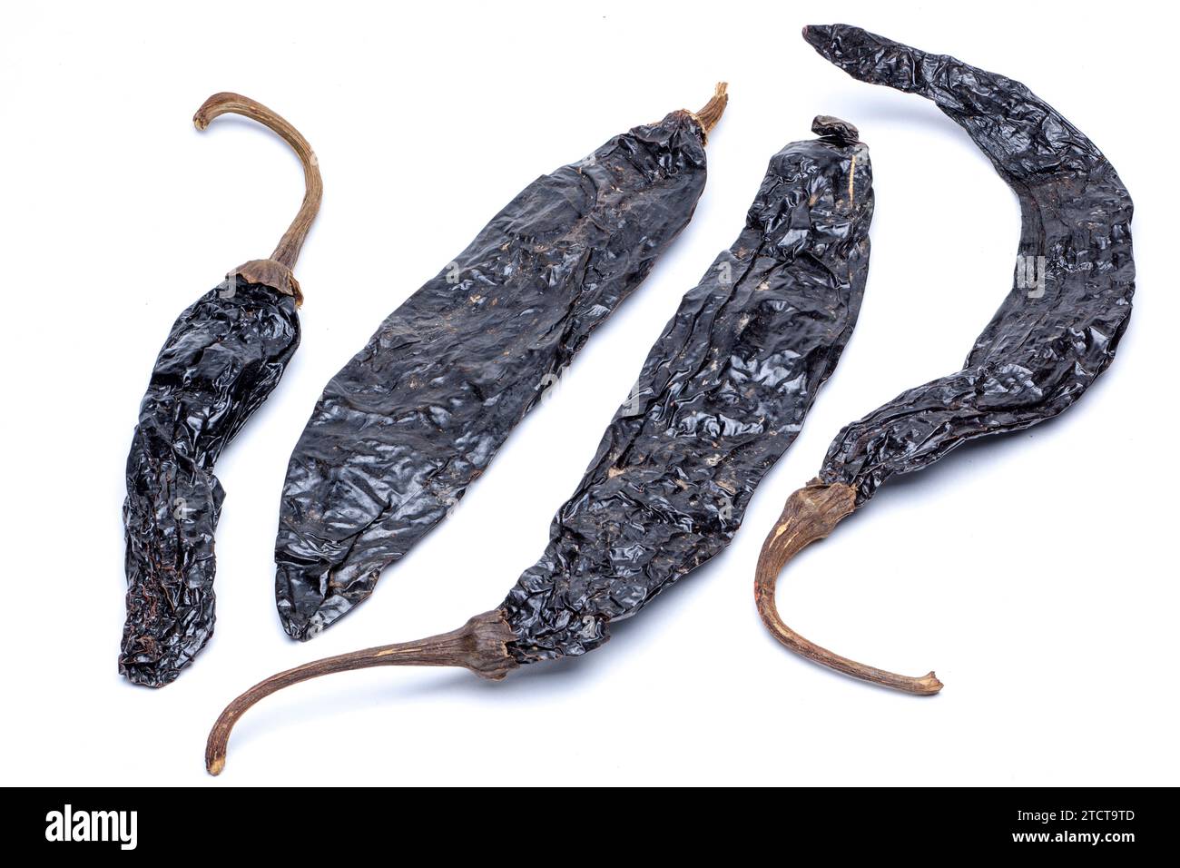 Four pasilla dried black chillies hi-res stock photography and images ...