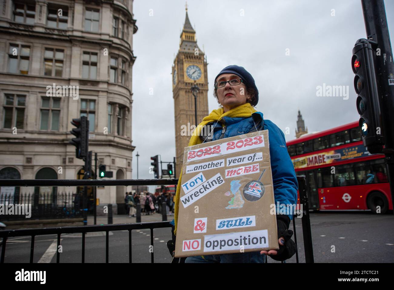 London, UK. 13th Dec, 2023. A protester holds a placard expressing her ...