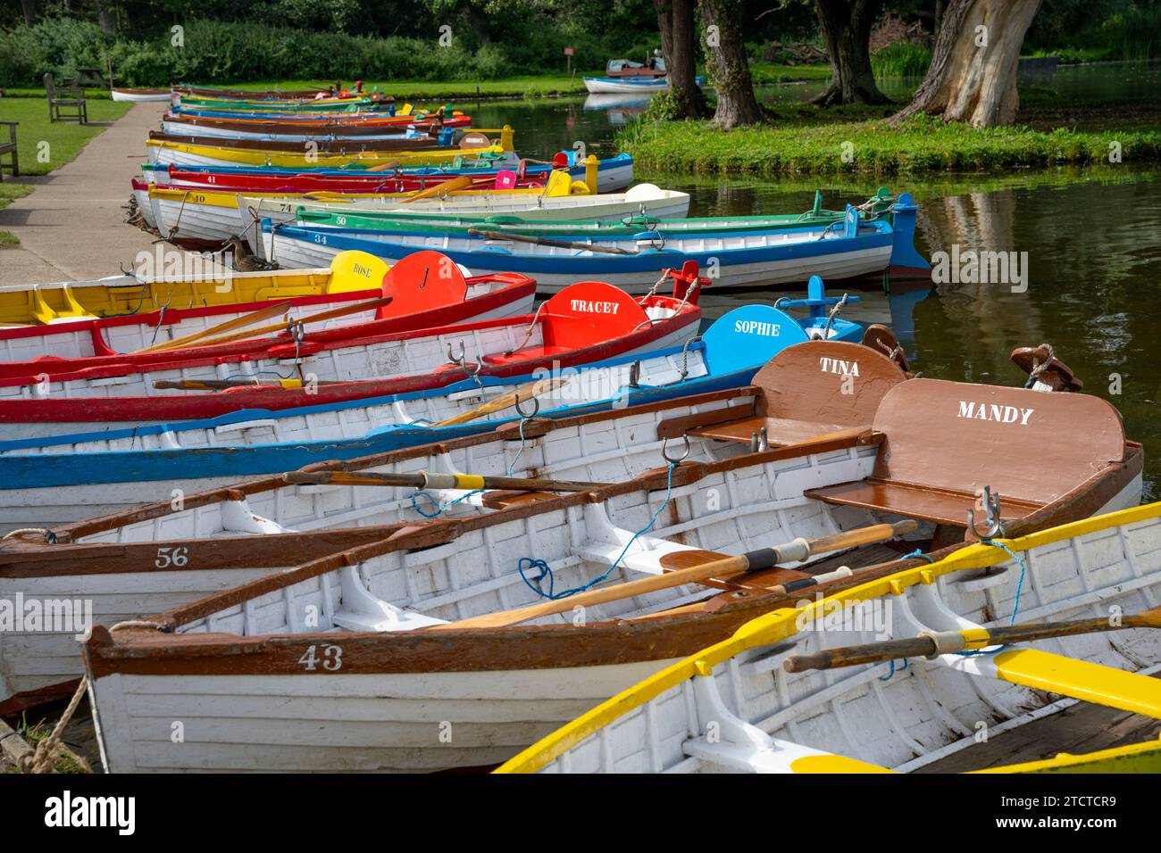 Colourful rowing boats on the Meare at Thorpeness, Suffolk, England, UK ...