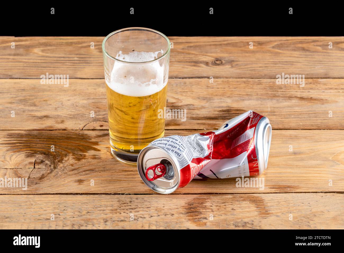 Moscow, Russia - December 08, 2023: Crumpled can of Bud beer, glass ...