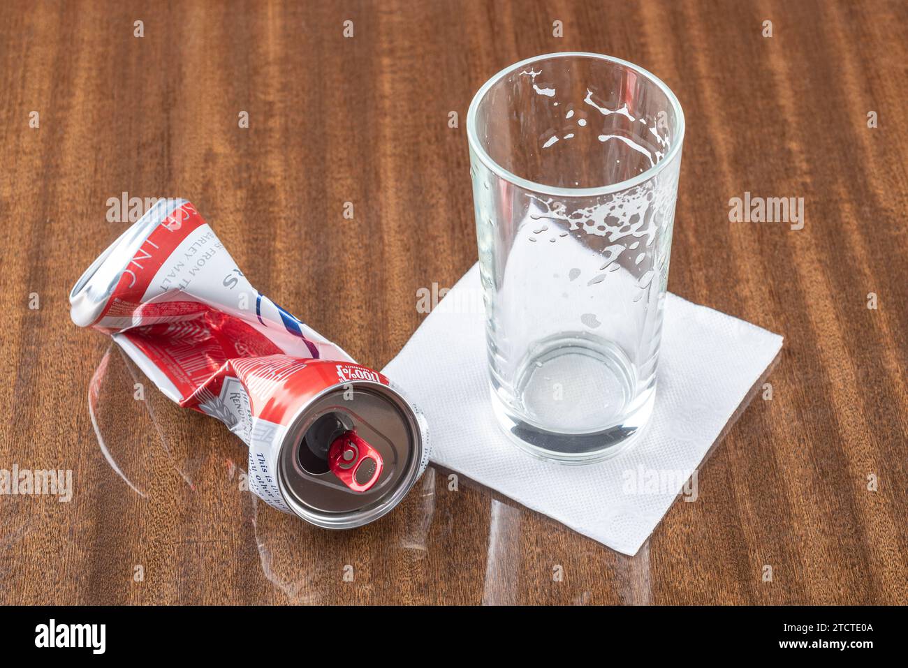 Moscow, Russia - December 08, 2023: An empty beer glass and a crumpled ...