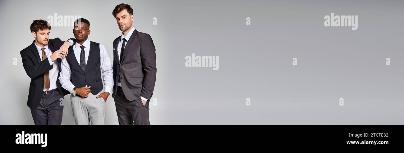 young multiracial friends in smart business suits posing together on ...