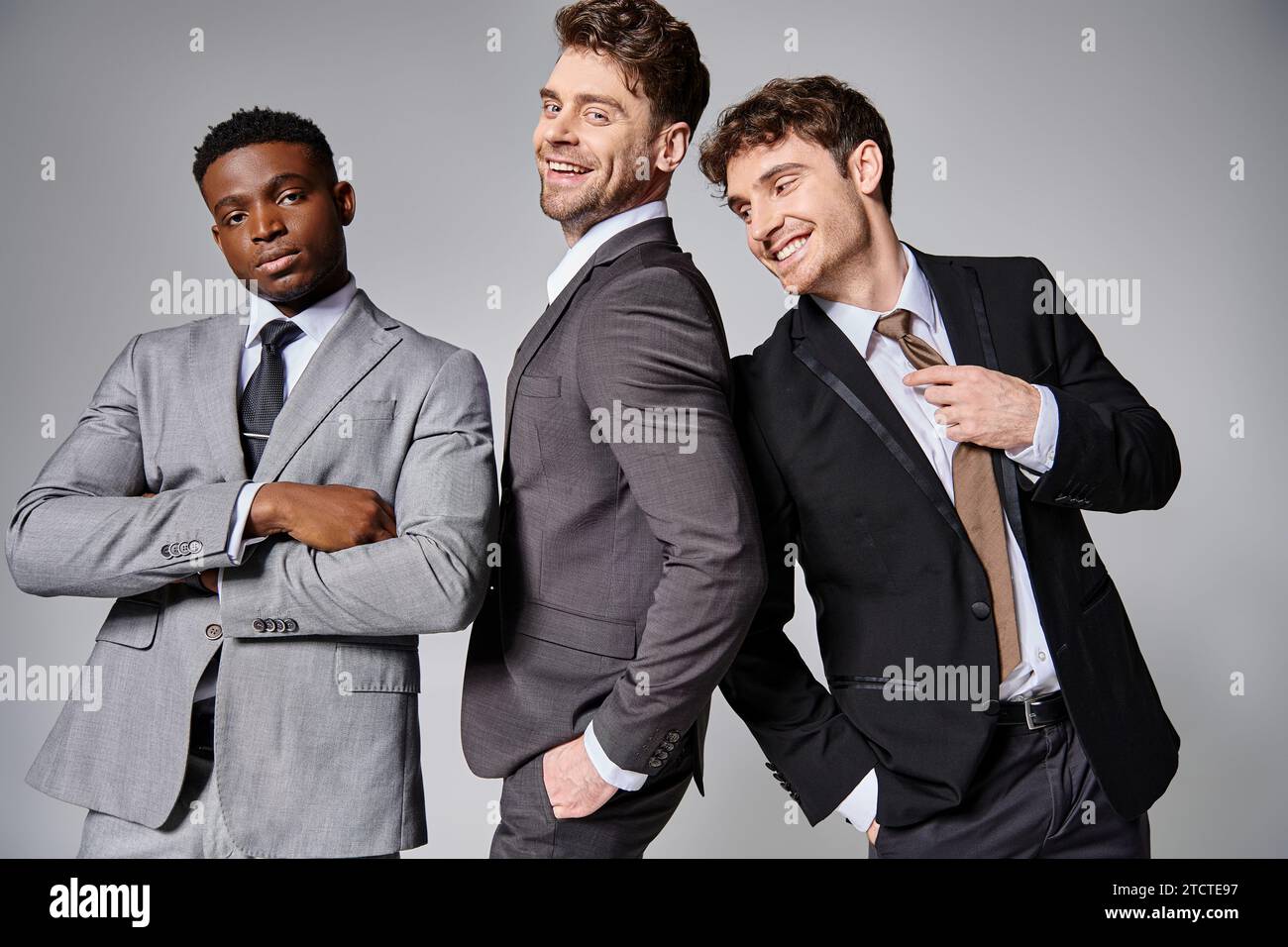 jolly multicultural friends in business casual outfits posing on gray ... jolly multicultural friends in business casual outfits posing on gray ...