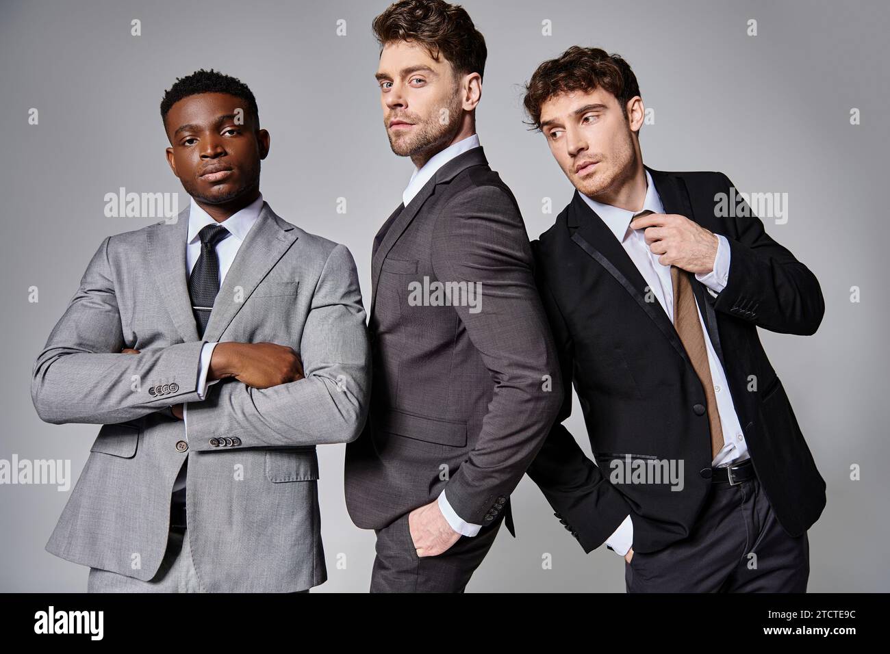 young handsome multicultural men in business smart suits posing ...