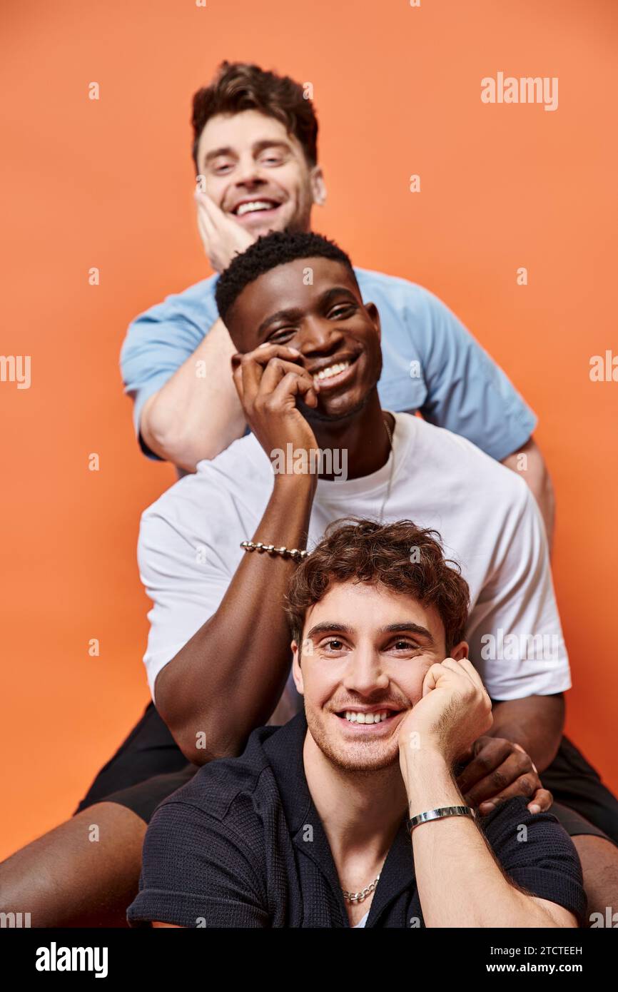 good looking diverse friends in street clothes posing together and ...