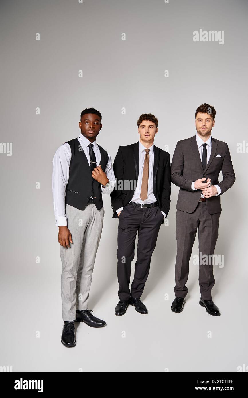 good looking young multicultural friends in smart business suits posing ...