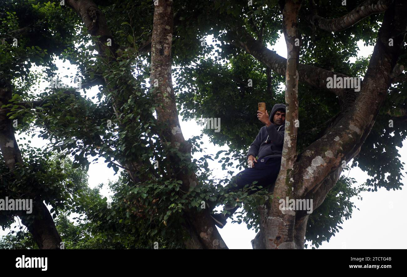 Dhading, Bagmati, Nepal. 14th Dec, 2023. A man takes photos of the ...