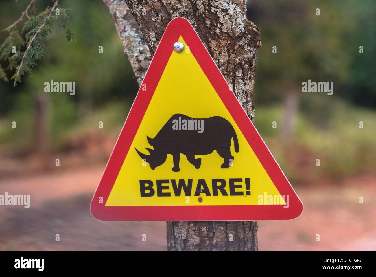 Warning sign post at the entrance of the Ziwa Rhino Sanctuary Stock ...