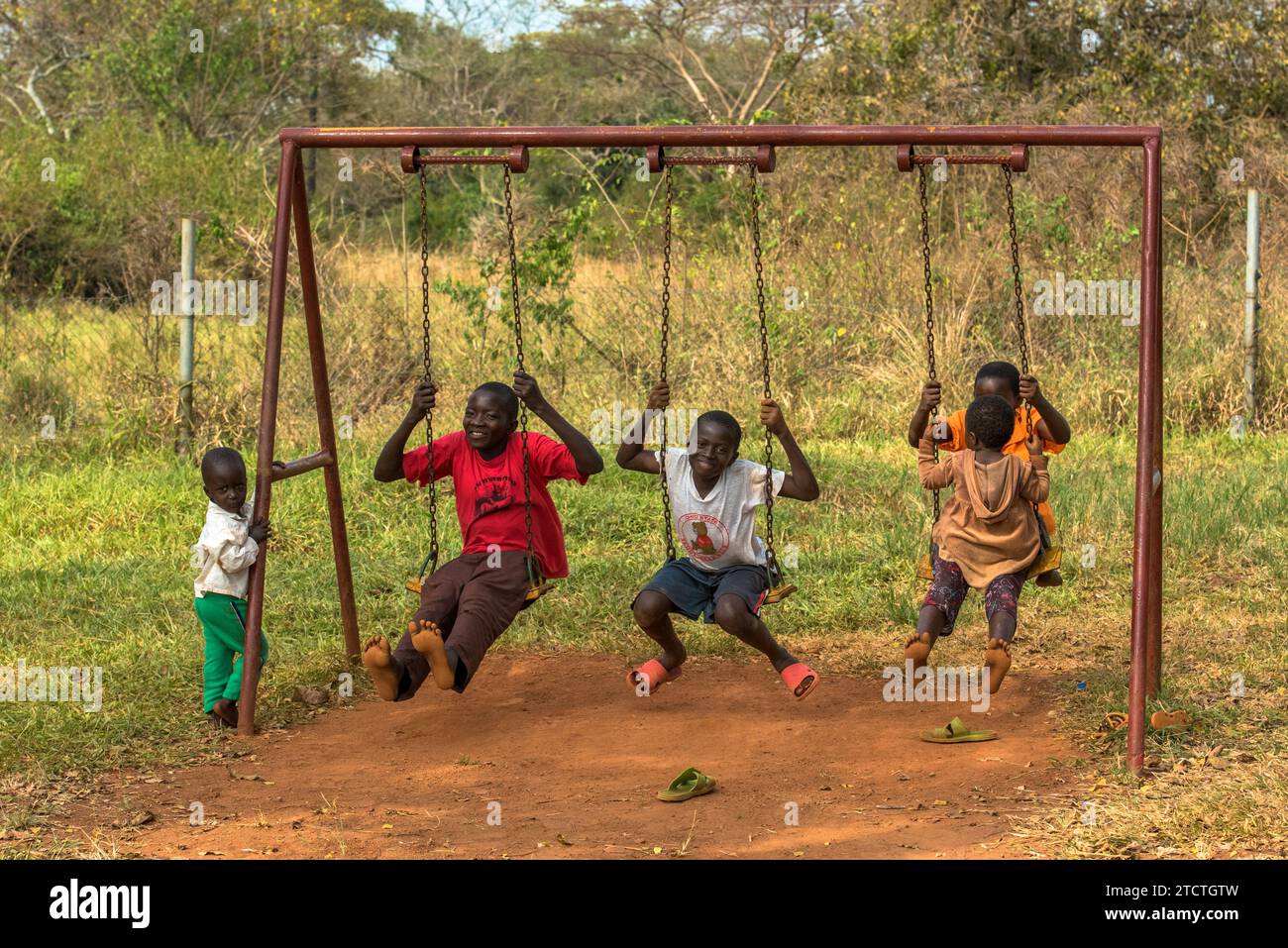 School kids swinging in the school yard, Ziwa, Uganda Stock Photo - Alamy