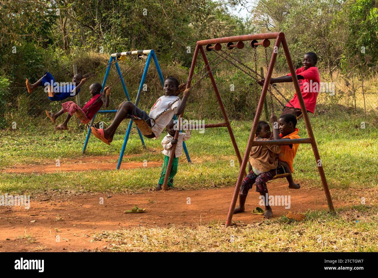 School kids swinging in the school yard, Ziwa, Uganda Stock Photo - Alamy
