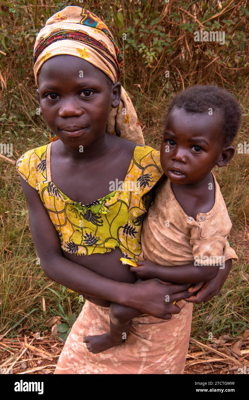 Young girl holding her baby brother, lac Albert, Uganda Stock Photo - Alamy