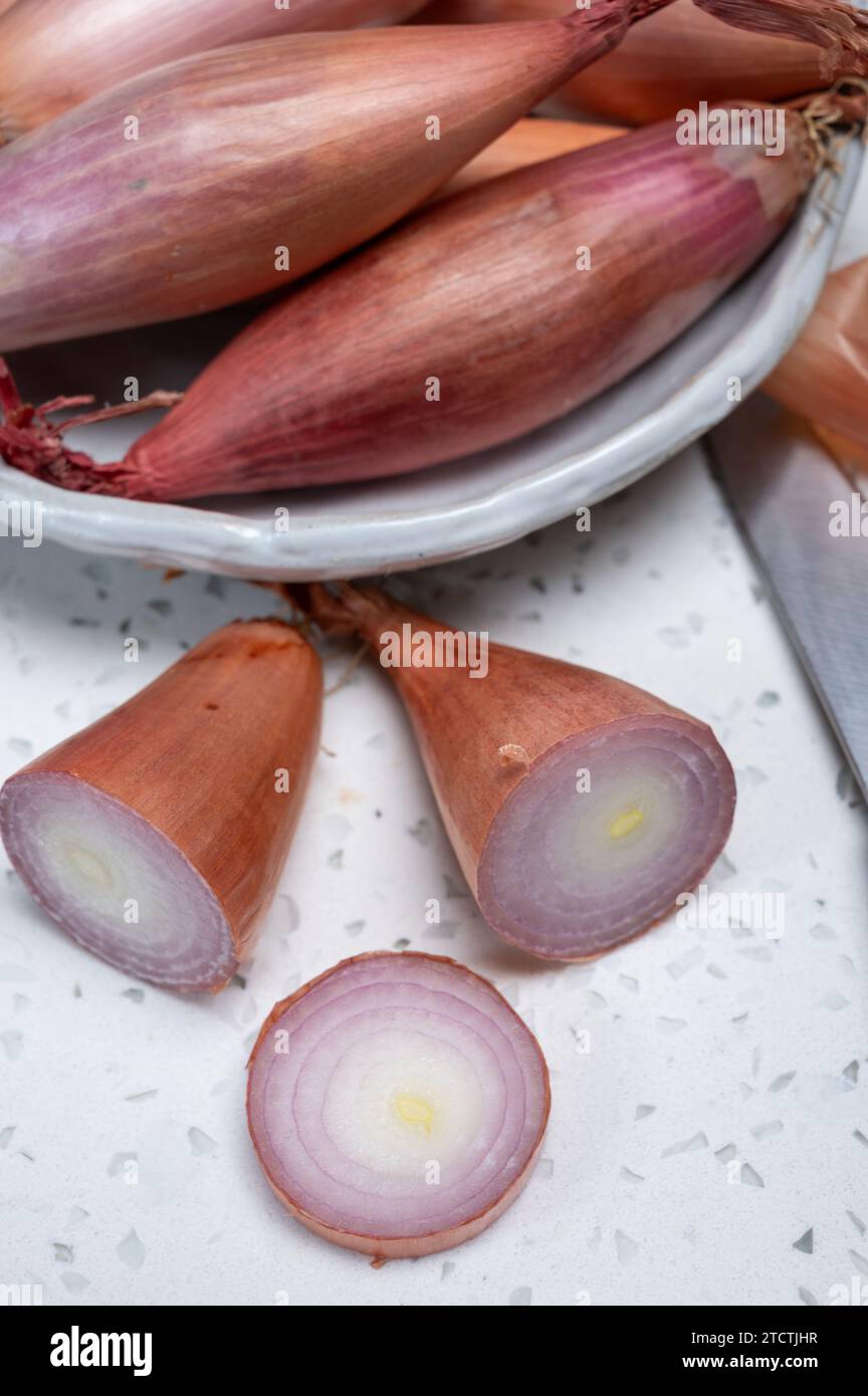 French long pink shallots grappe onion from Brittany, France close up ...