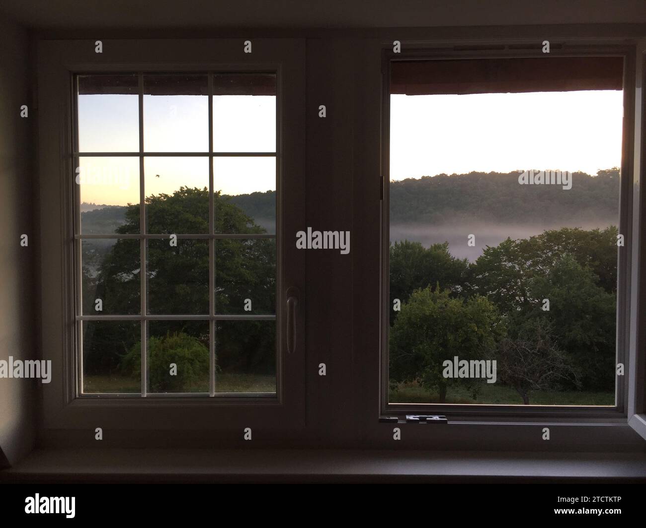 Window on garden and mist in Le Mesnil en Ouche, Eure, France Stock ...