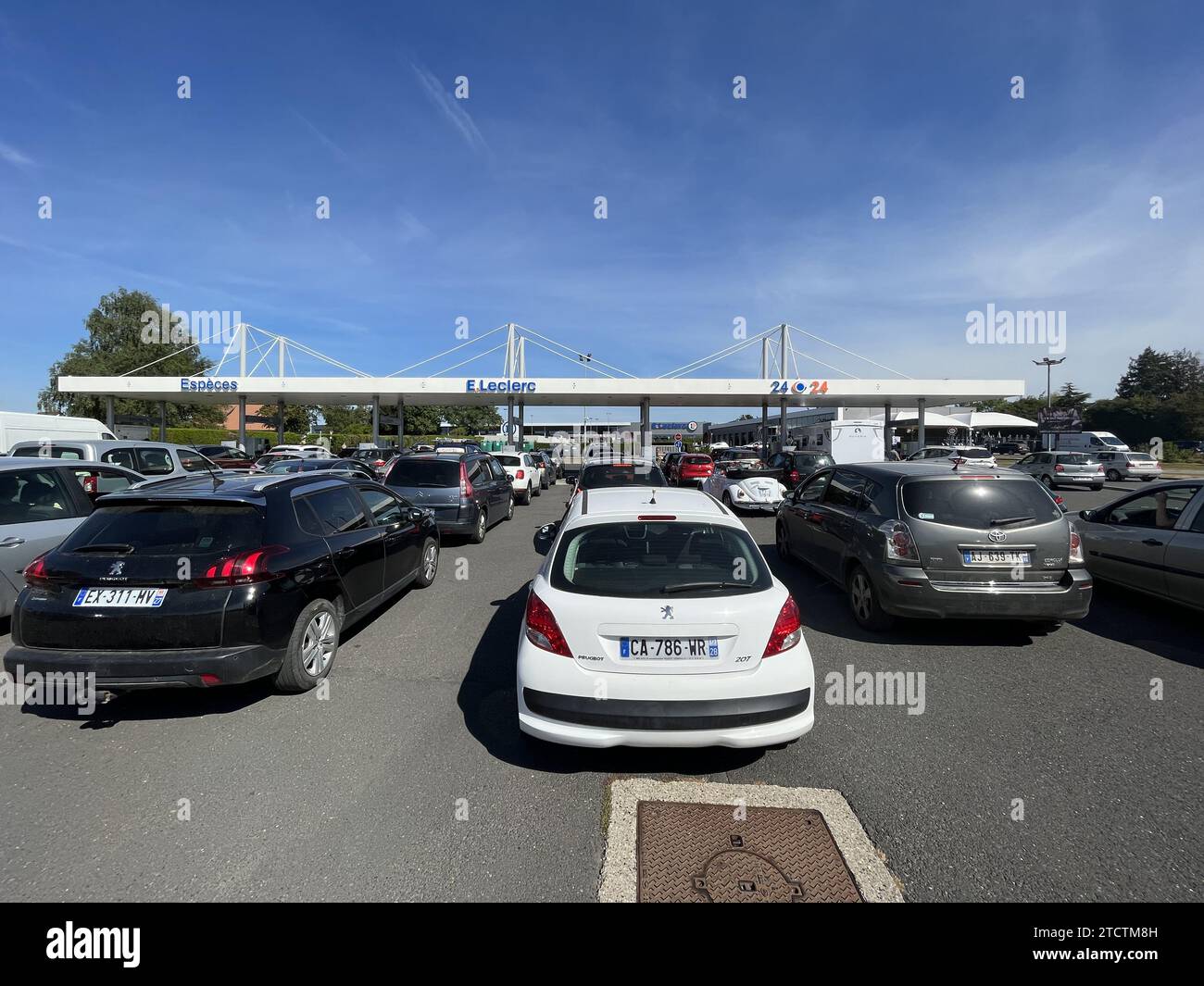 Cars lining to gaz up in Bernay, Eure, France Stock Photo - Alamy