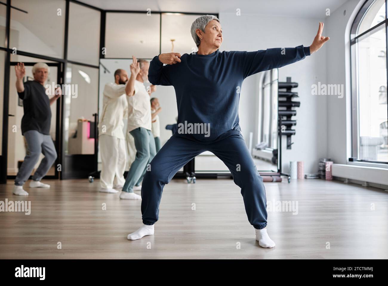 Senior Woman Practicing Qigong Archer Pose Stock Photo - Alamy