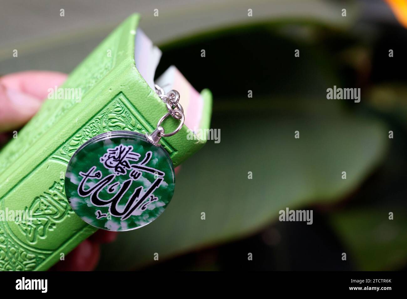 The Quran, holy book of Muslims from God with Allah monogram. Symbols ...