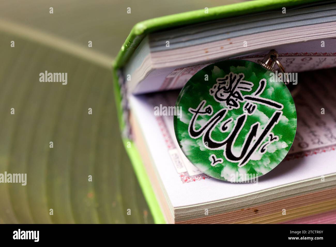 The Quran, holy book of Muslims from God with Allah monogram. Symbols ...
