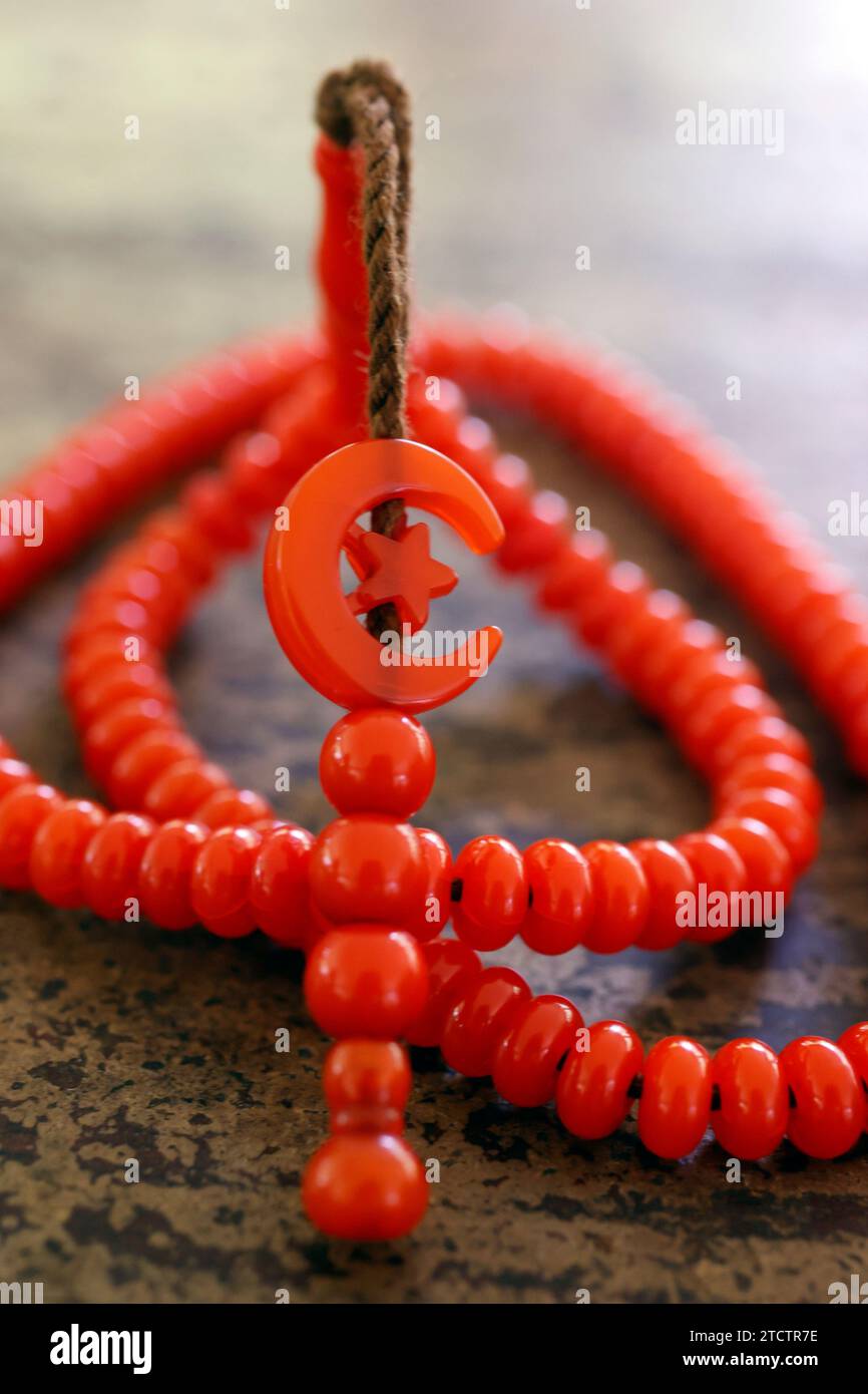 Red tasbih ( muslim prayer beads ) with star and crescent. Symbol of ...