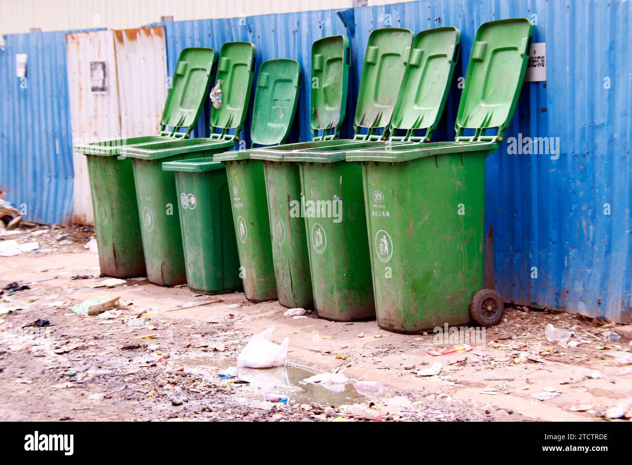 Open green plastic trash cans in the street Stock Photo - Alamy