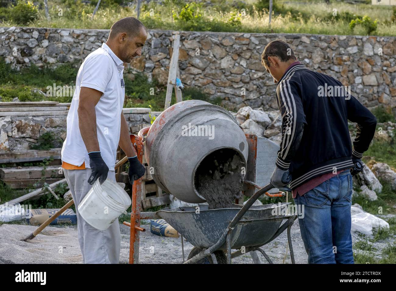 Builders making cement in a village overlooking Podgorica, Montenegro ...
