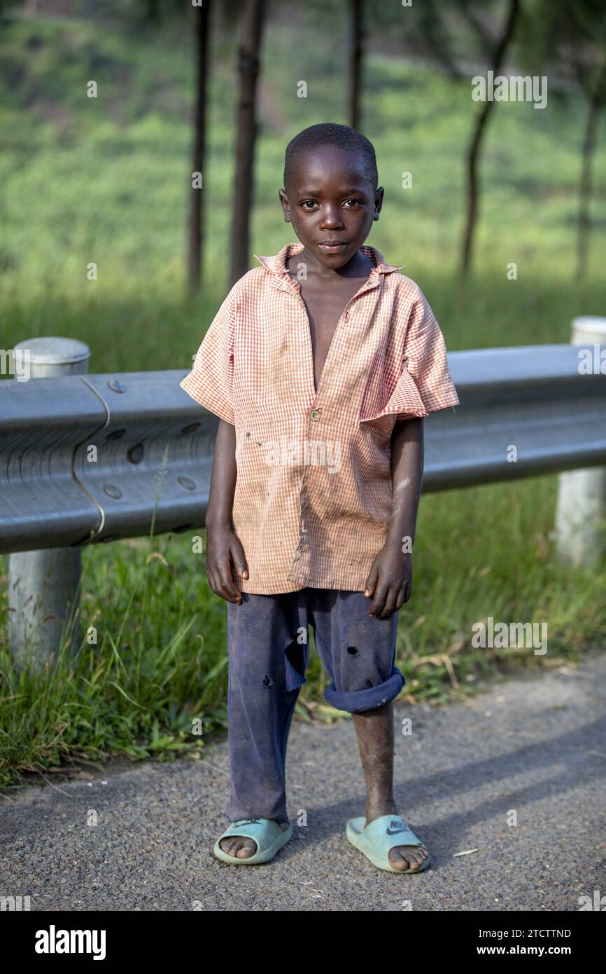 Boy standing on a roadside and looking at camera near Karongi, Rwanda ...